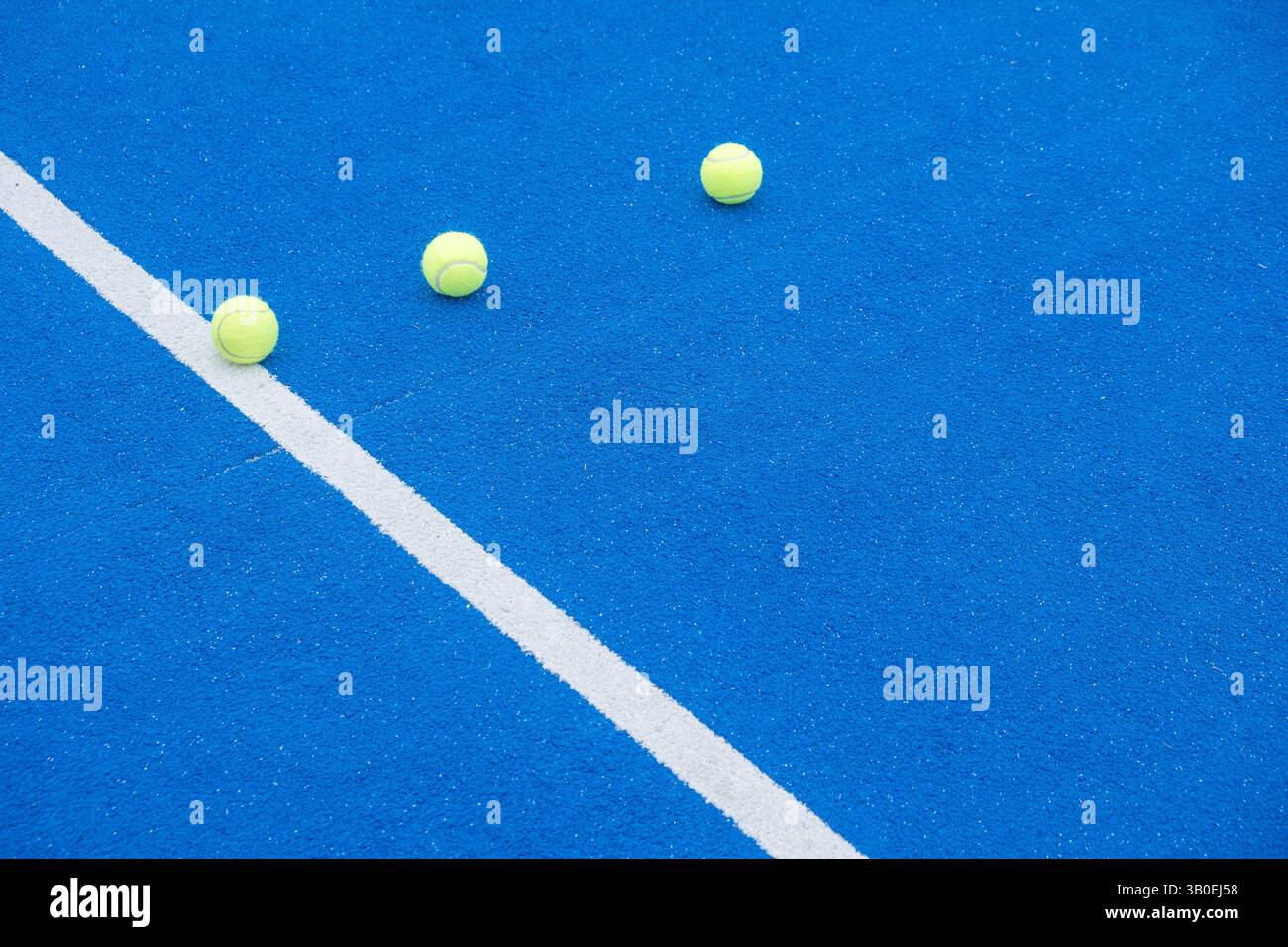 padel ball on a blue padel court near the line Stock Photo - Alamy