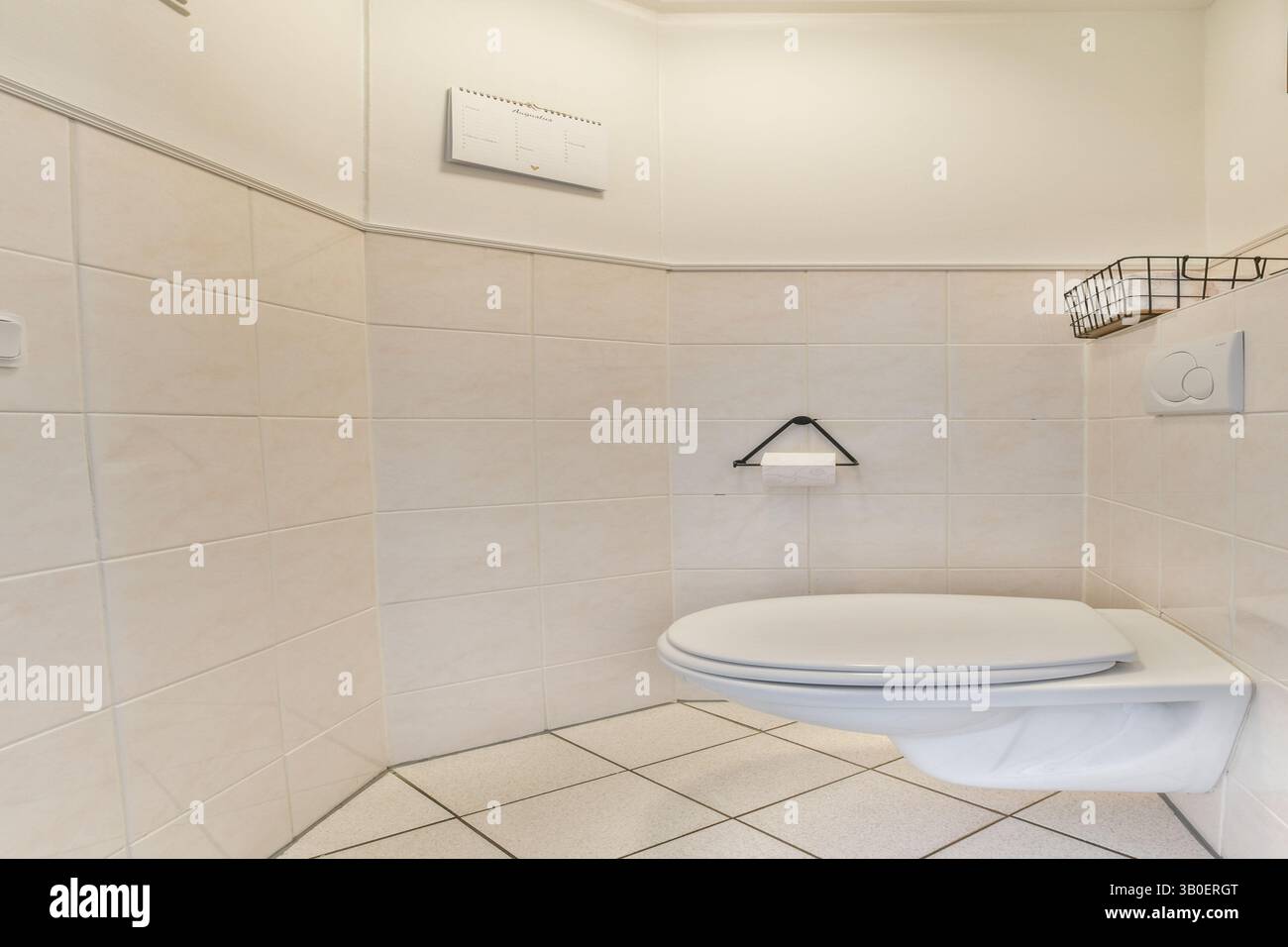 A sleek and modern bathroom featuring a clean design with light tiles ...
