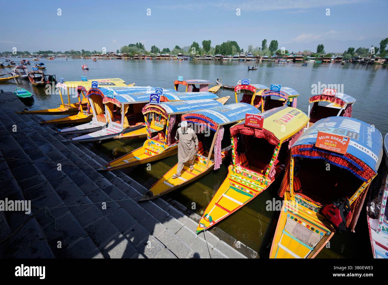 A Kashmiri boatman disembarks from a boat on the banks of Dal Lake in ...