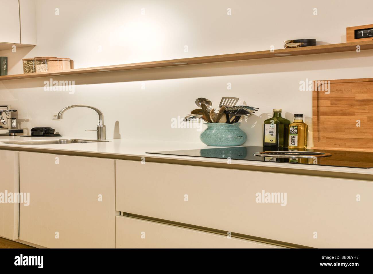 Sleek and contemporary kitchen featuring minimalist cabinetry, stylish ...