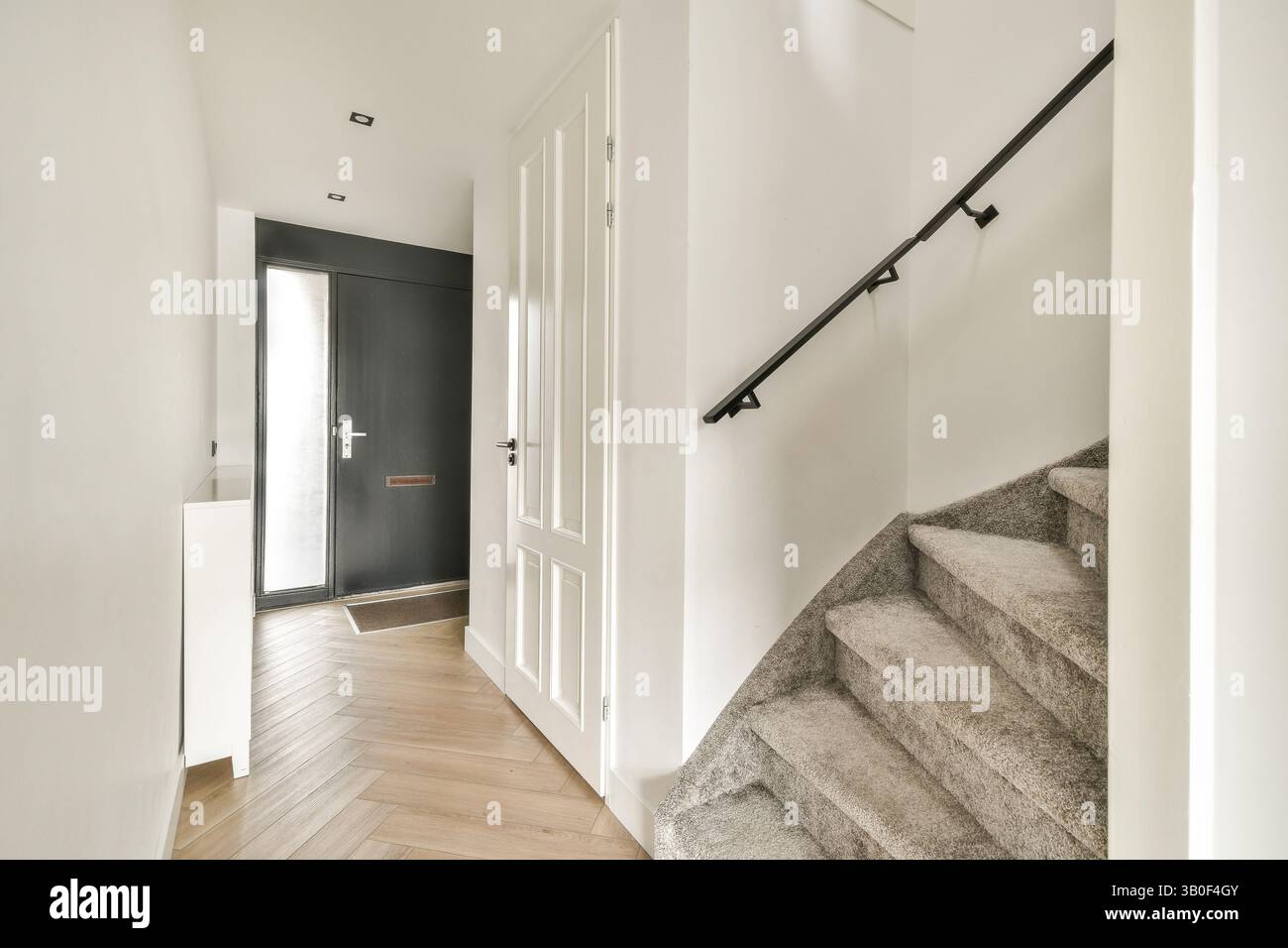 Bright and spacious entrance hall featuring a modern staircase ...