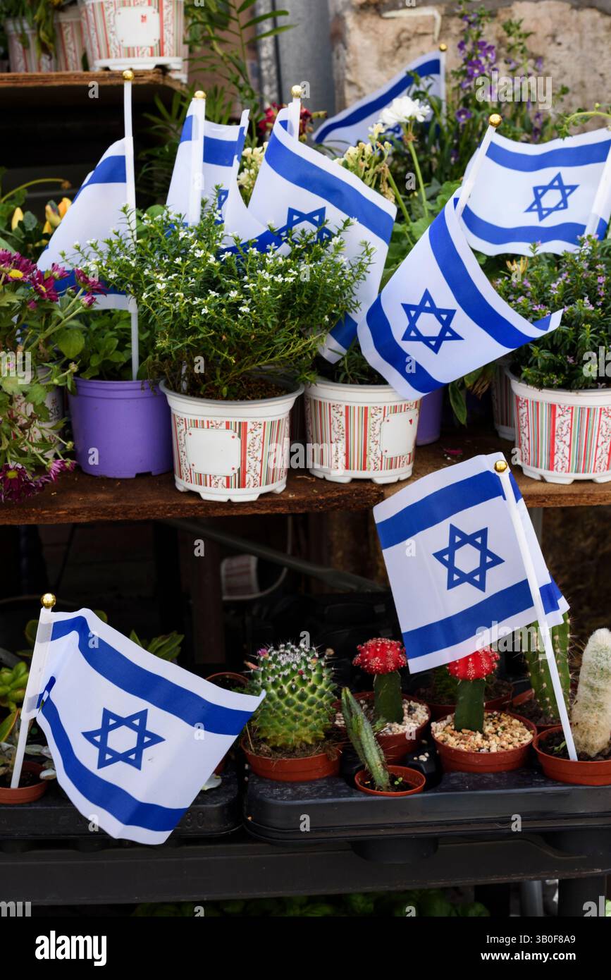 Blue and white flags of the State of Israel with a Jewish star placed ...