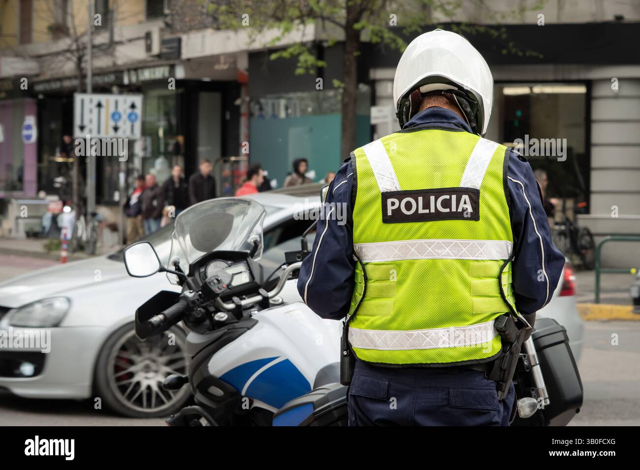 Policeman on duty on busy street of urban city. Police officer on the ...