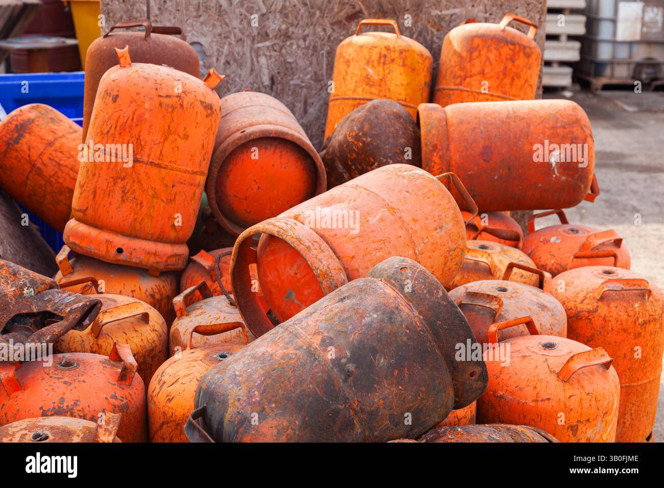 A pile of old used gas cylinders of small size. Scrap metal from gas ...