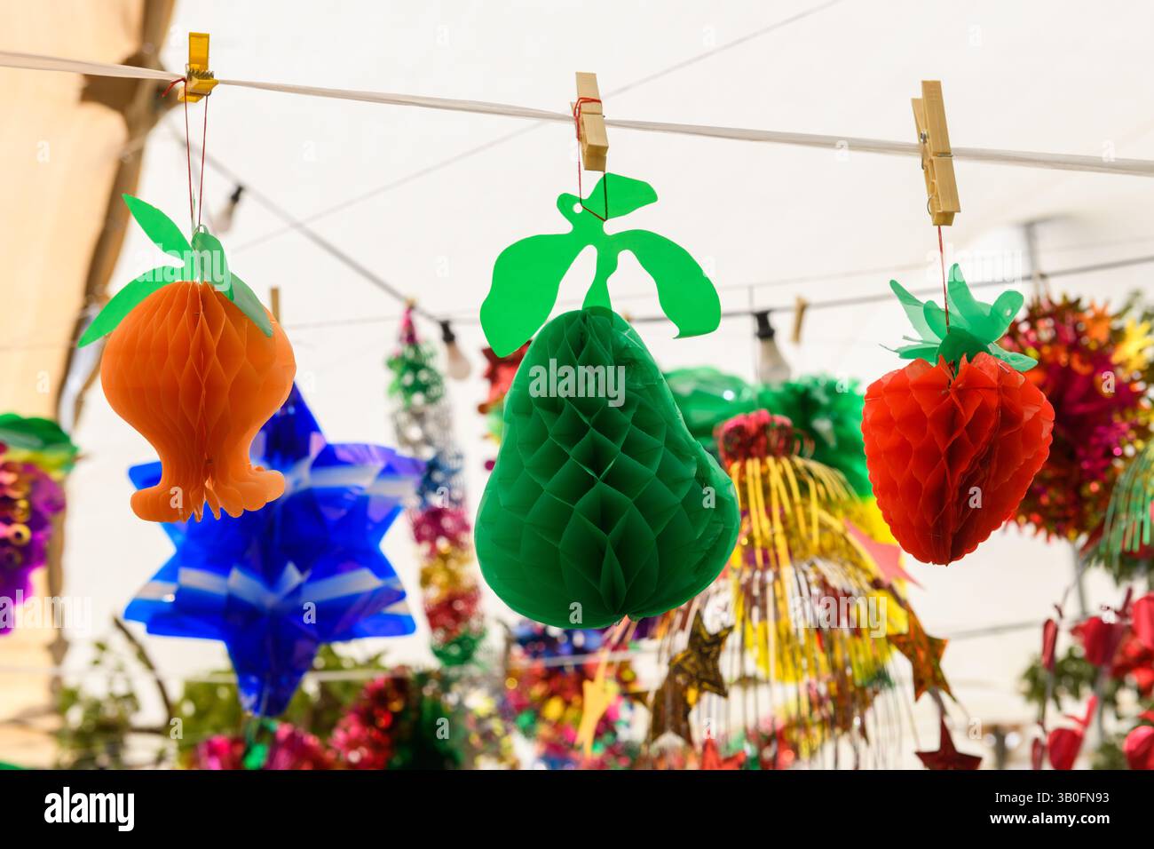 Colorful, paper fruit sculptures sold for decorating the sukkah, a ...