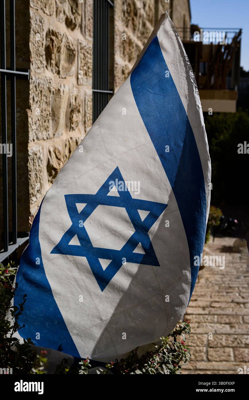 Blue and white flag of he State of Israel with a Jewish star displayed ...