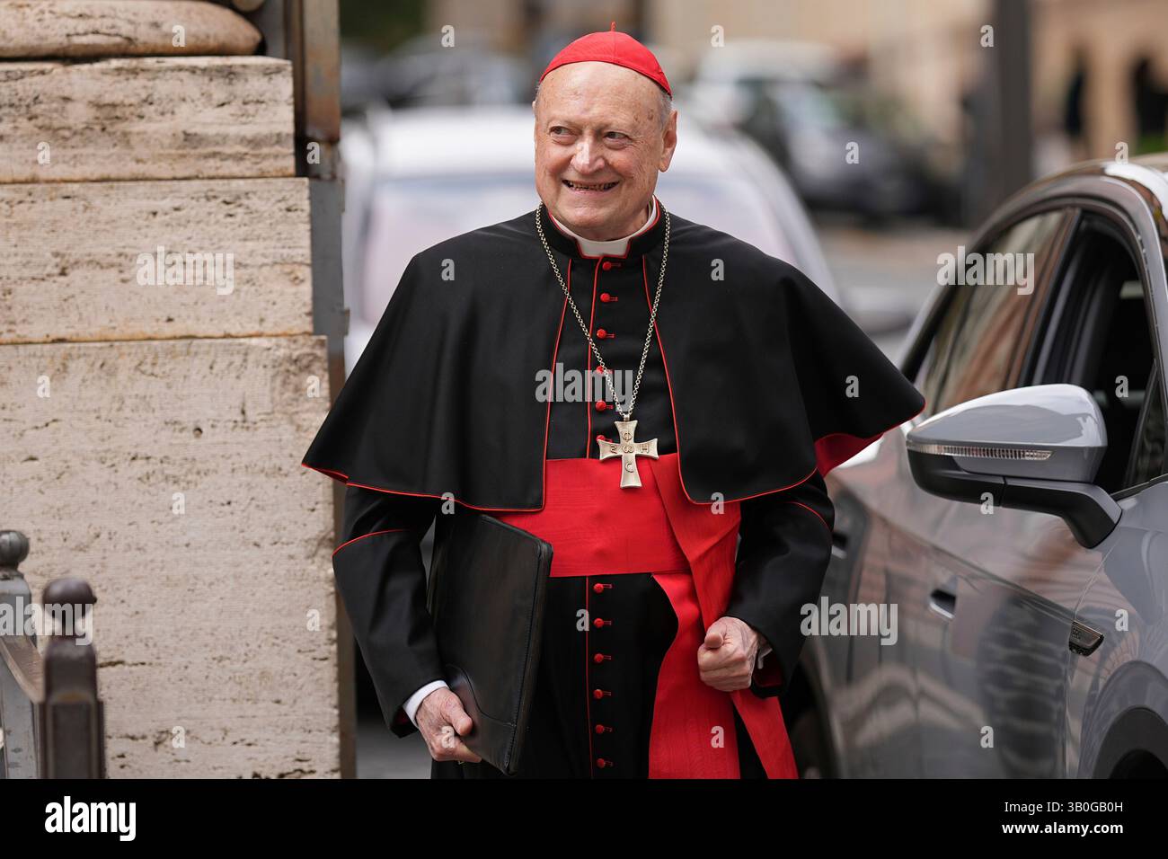 Cardinal Gianfranco Ravasi smiles before boarding a vehicle at the ...