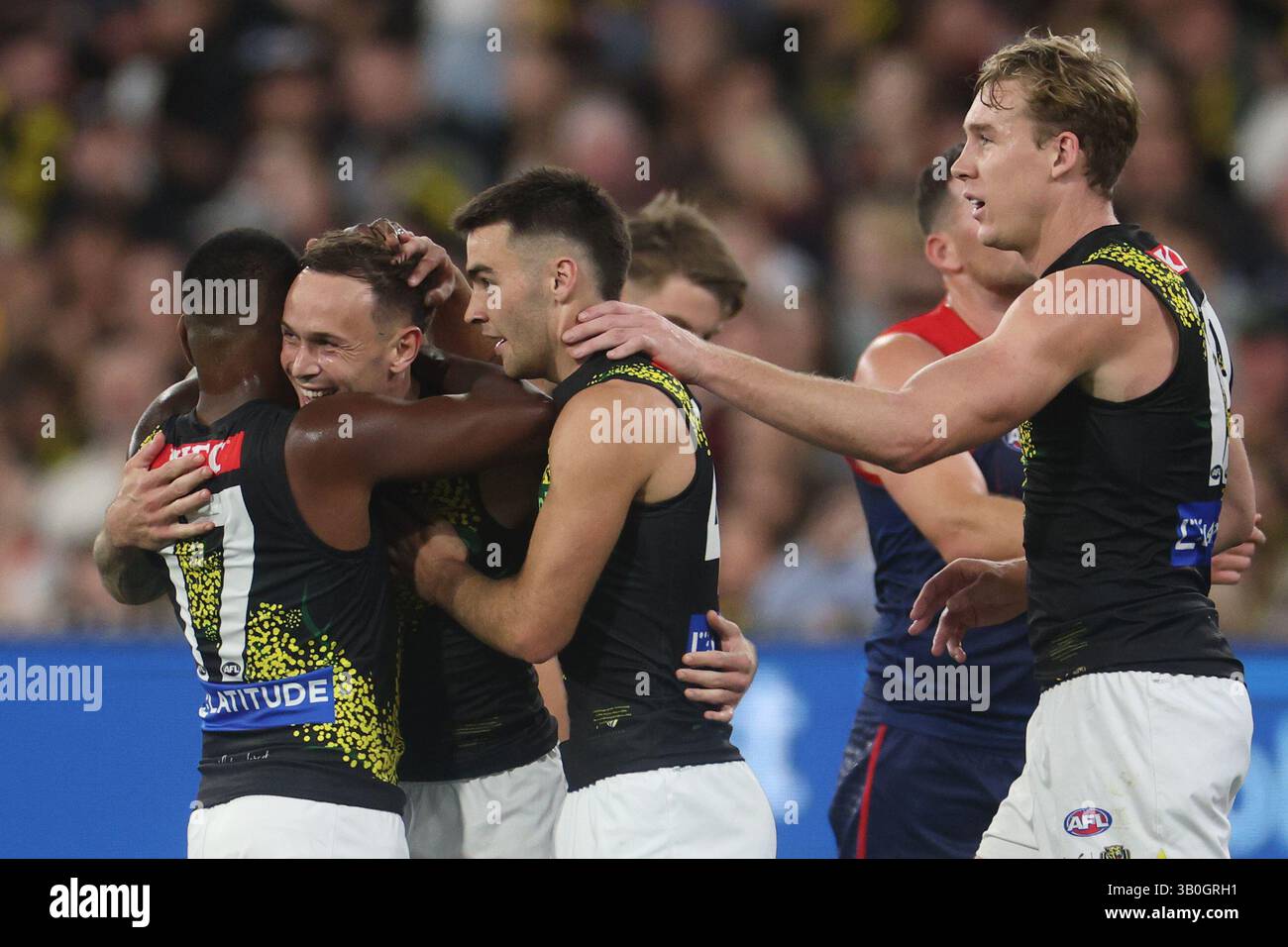 Rhyan Mansell of the Tigers (second left) celebrates kicking a goal ...