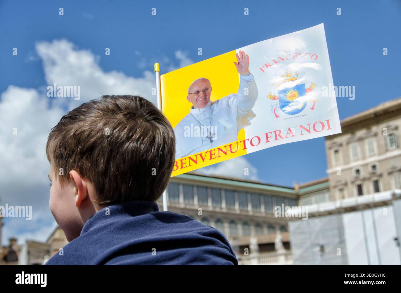 A child raises a banner in St. Peter's Square a few days after the ...