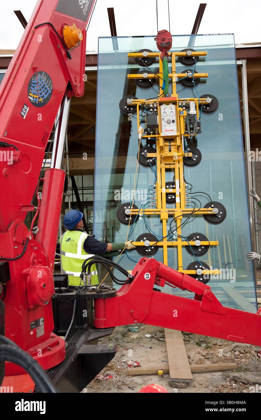 Installation of large glass panel on a building construction site Stock ...
