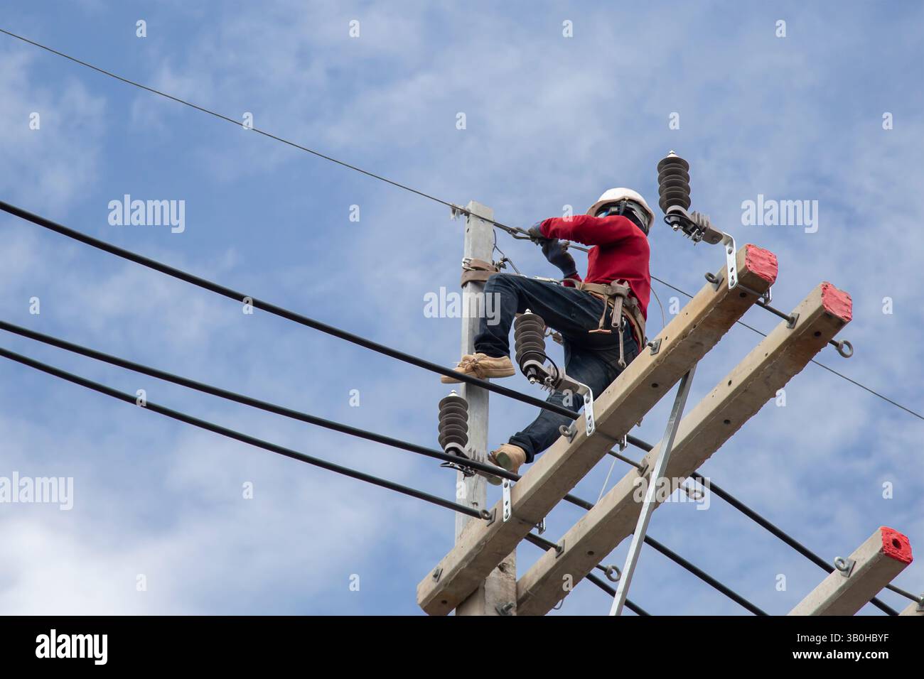 Electrician installing equipment on pole Stock Photo - Alamy