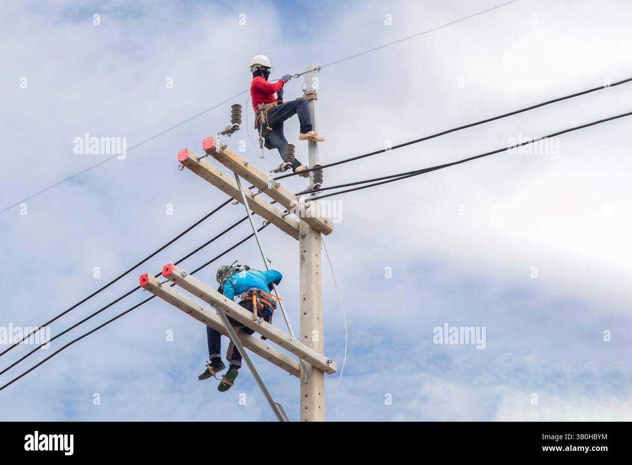 Electrician installing equipment on pole Stock Photo - Alamy