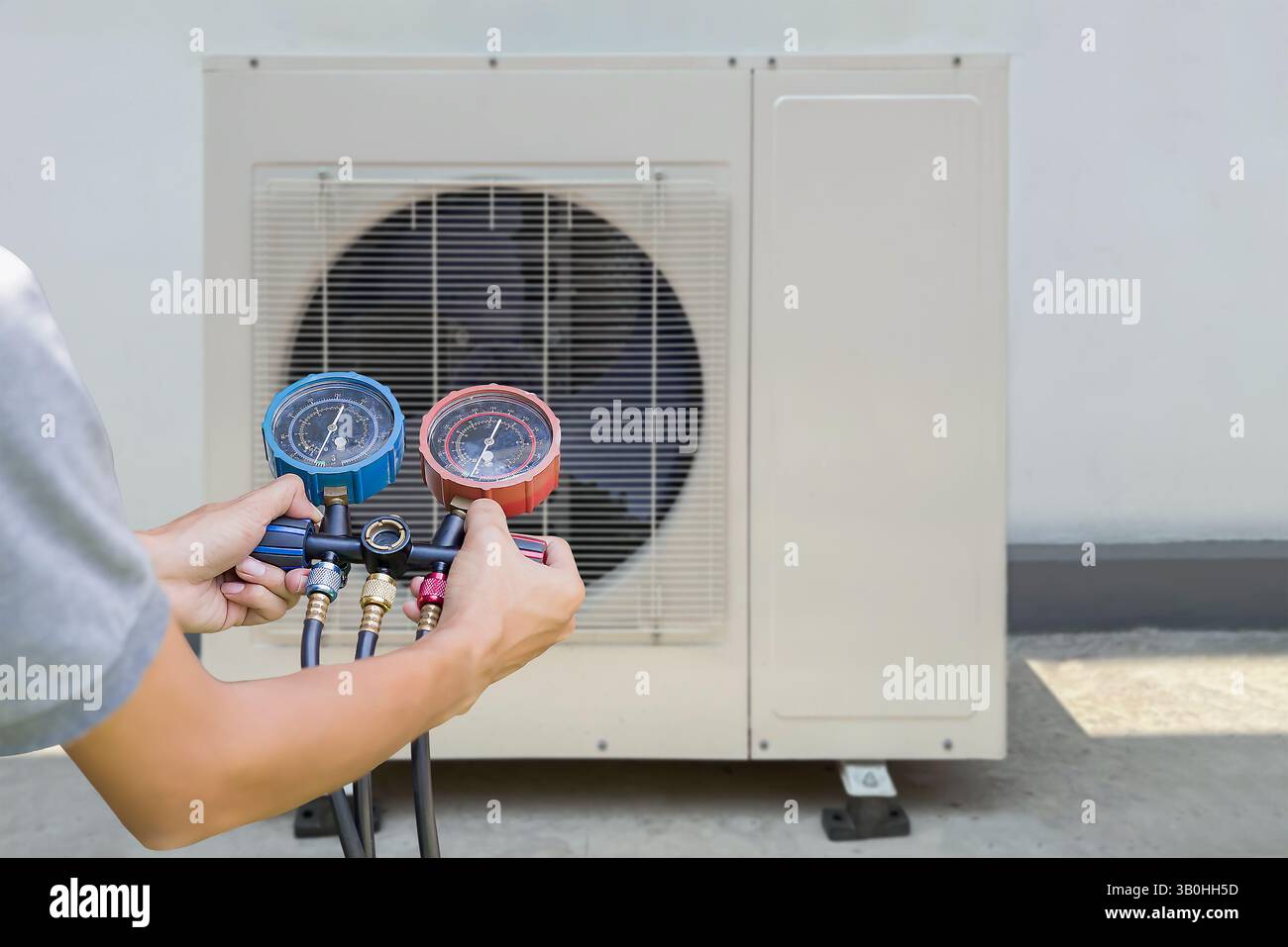 Air conditioning, HVAC service technician using gauges to check ...