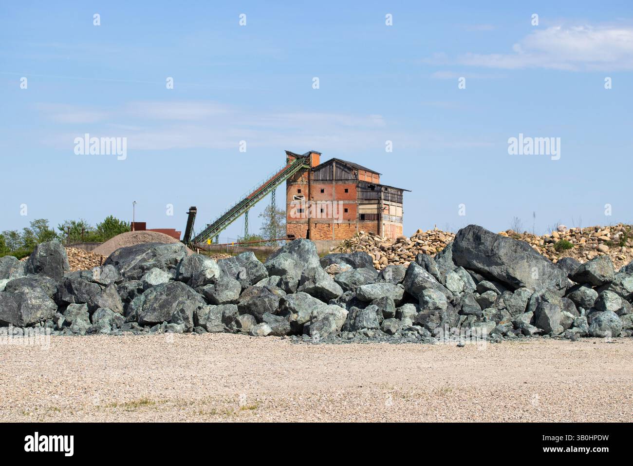 Mining site with rock heaps processing plant and machinery under a ...