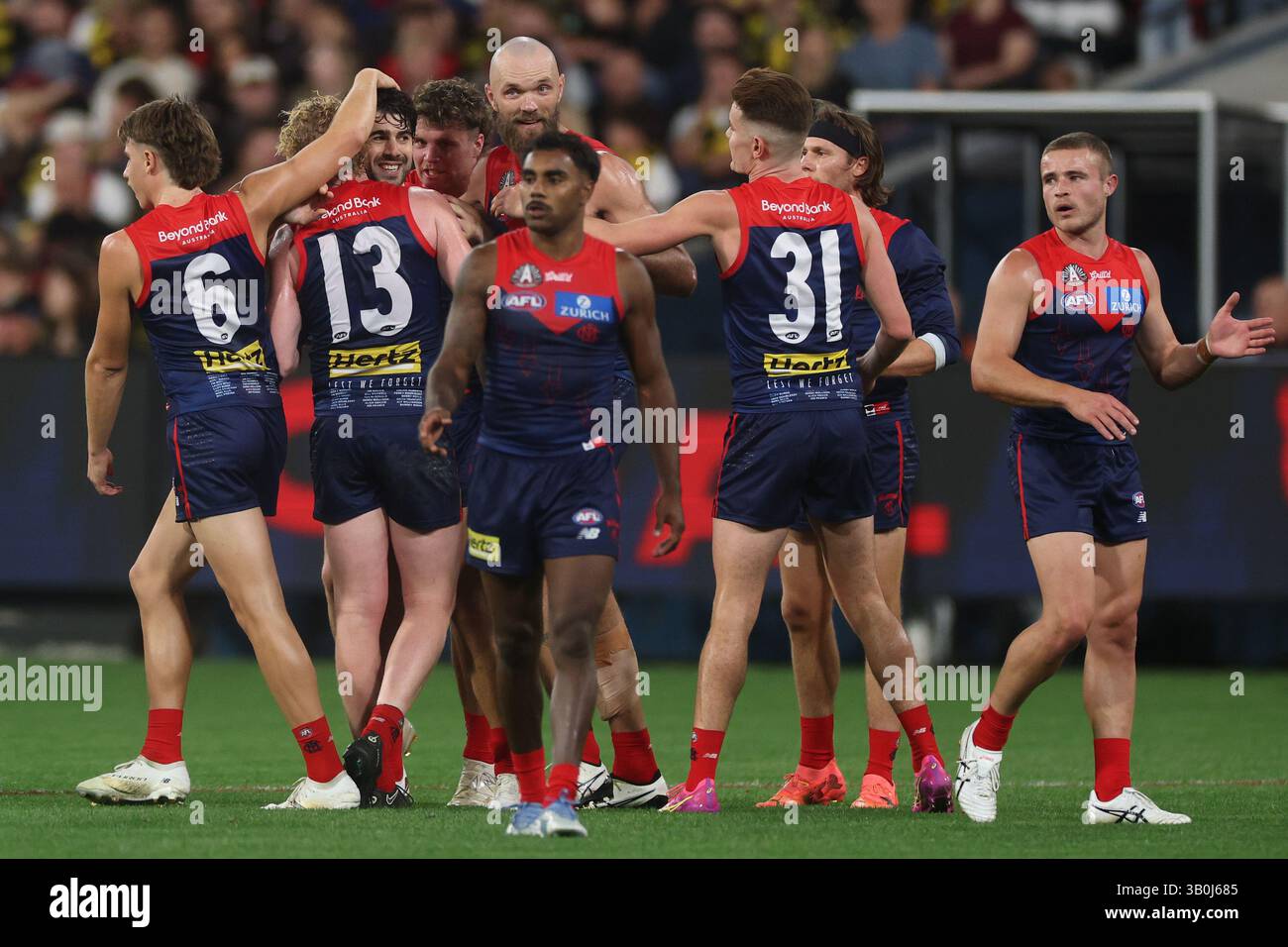 Christian Petracca of the Demons (third left) celebrates kicking a goal ...