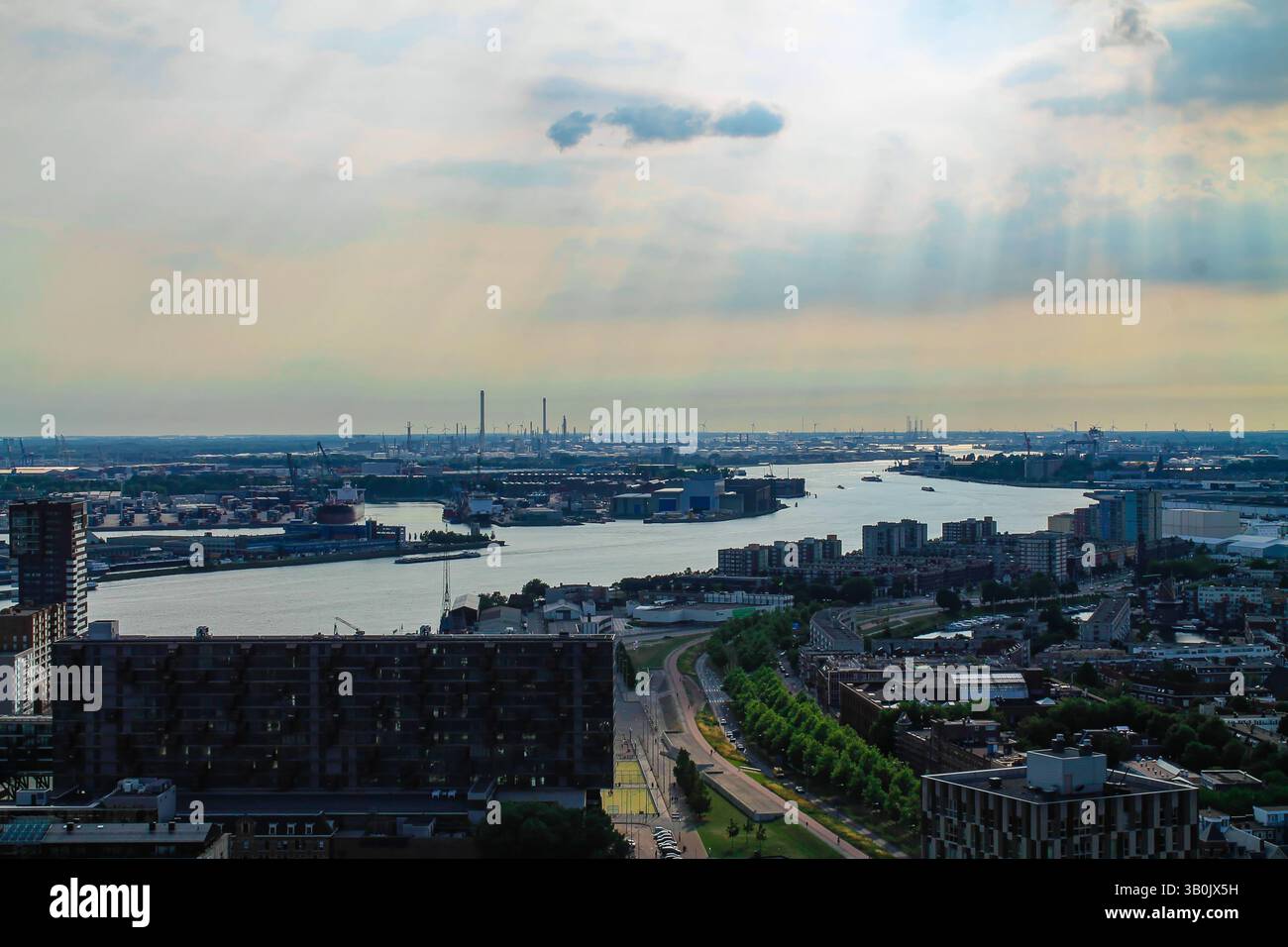 A panoramic view of a cityscape featuring a river, industrial areas ...