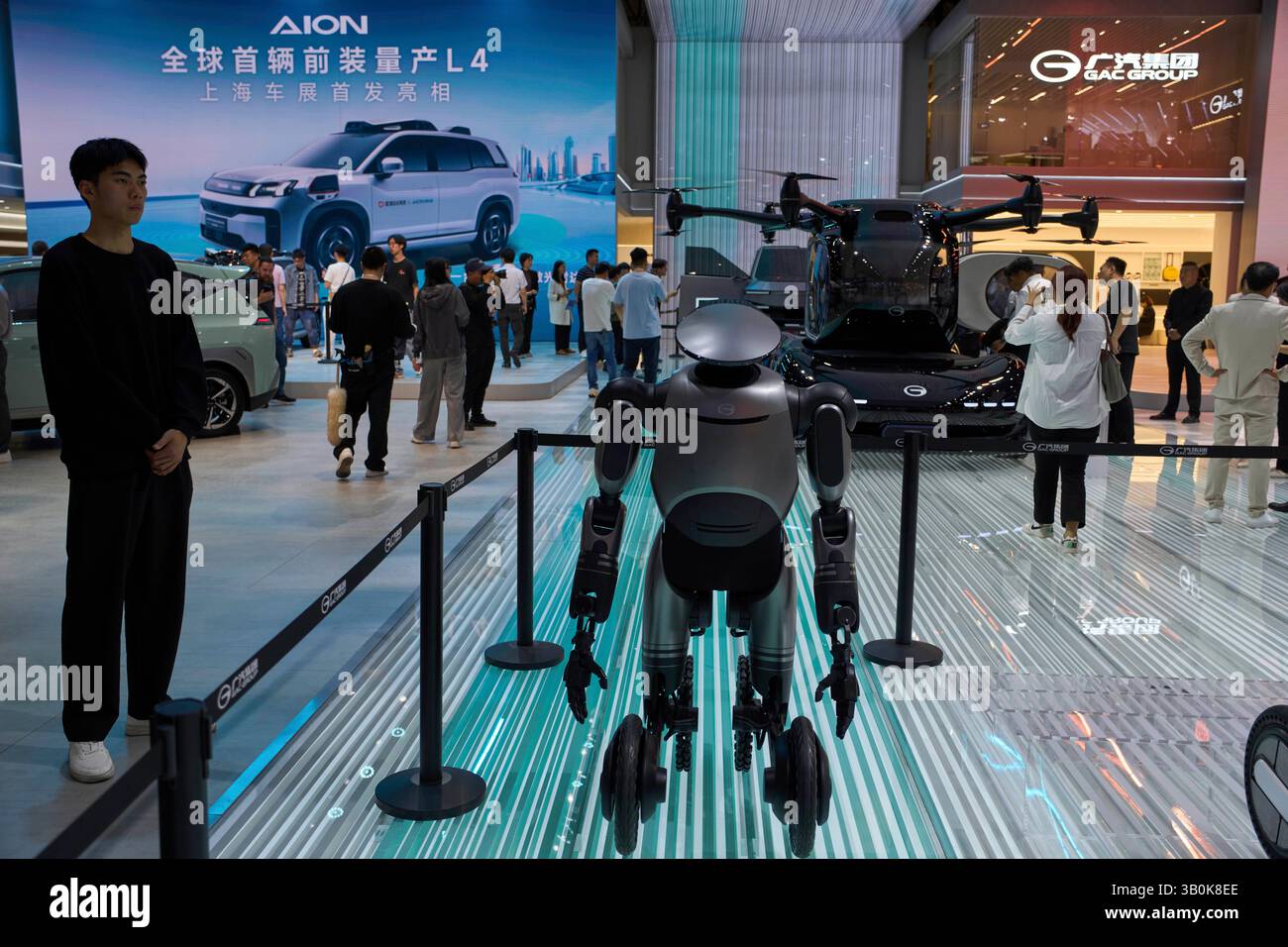 A wheeled robot and a flying vehicle is displayed at the AION and GAC Group booths at the ...