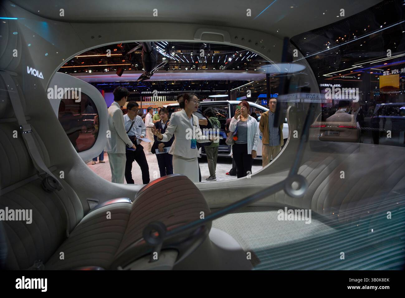 A worker introduces GOVY Air Car from GAC Group displayed at the ...