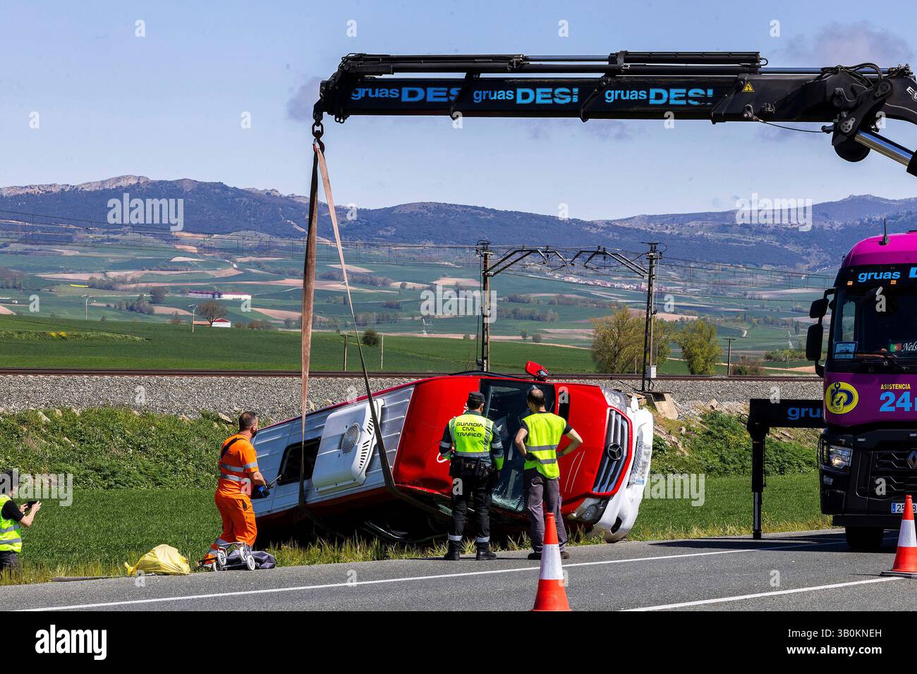 A crane lifts the crashed minibus, on April 24, in Berzosa de Bureba ...