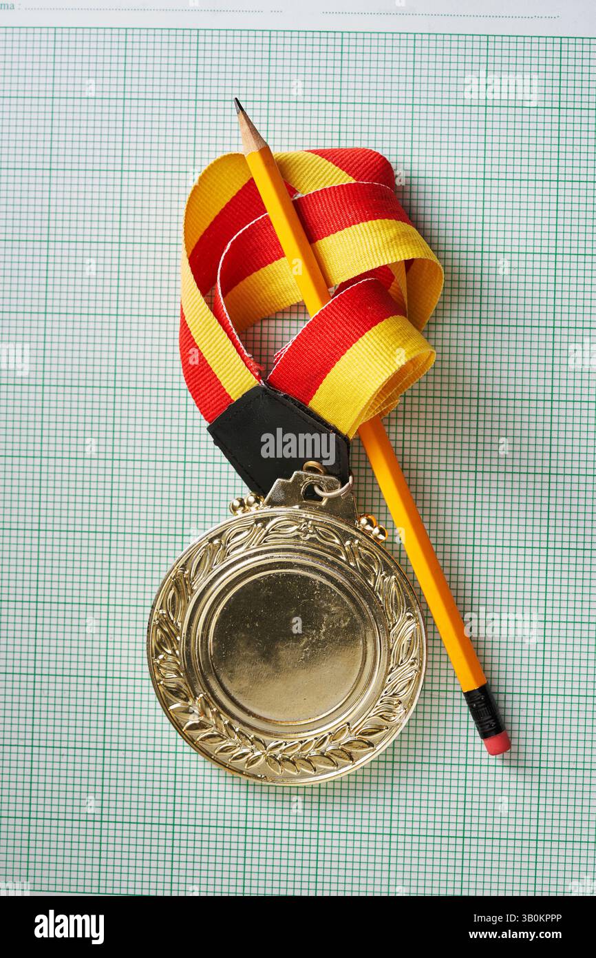 gold medal with ribbon and pencil on graph paper Stock Photo - Alamy