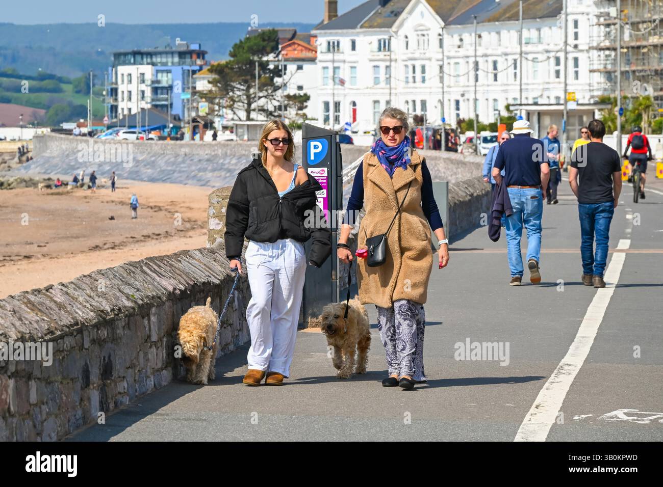 Exmouth, Devon, UK. 24th April 2025. UK Weather: Walkers on the ...