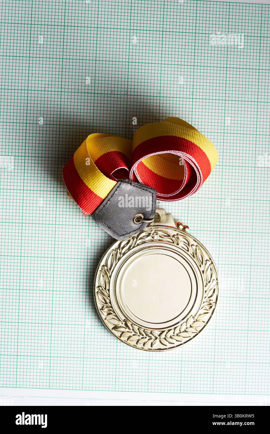 gold medal with ribbon on graph paper Stock Photo - Alamy