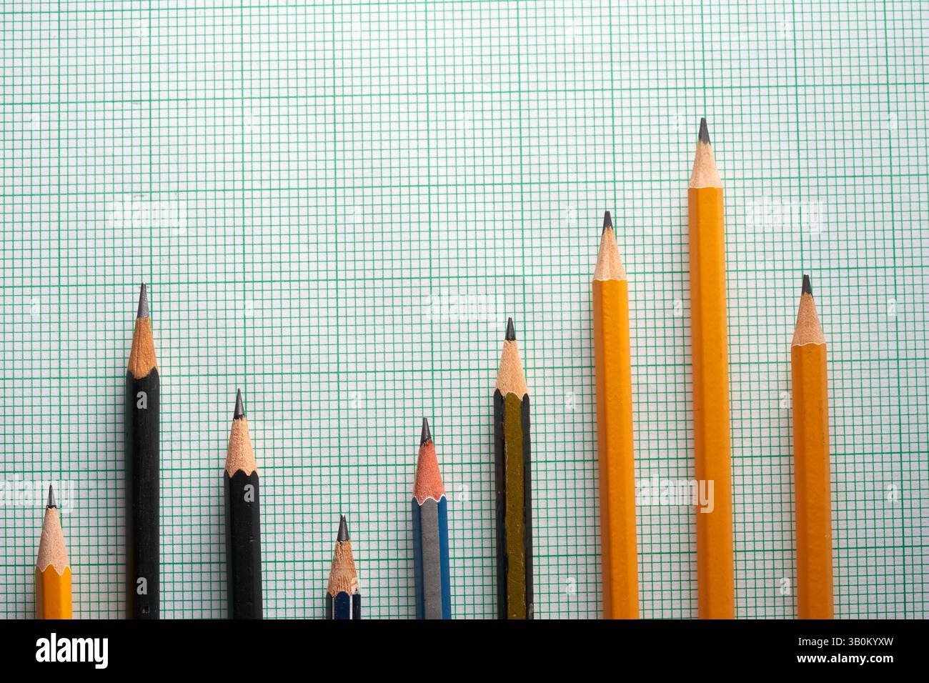 pencils forming a bar graph on a graph paper Stock Photo - Alamy