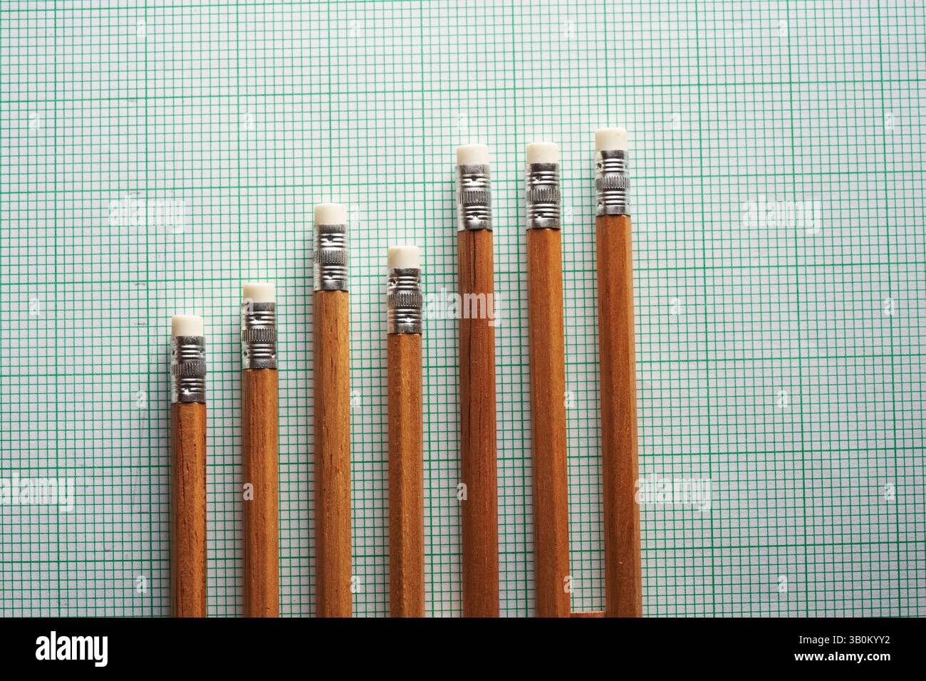 pencils forming a bar graph on a graph paper Stock Photo - Alamy
