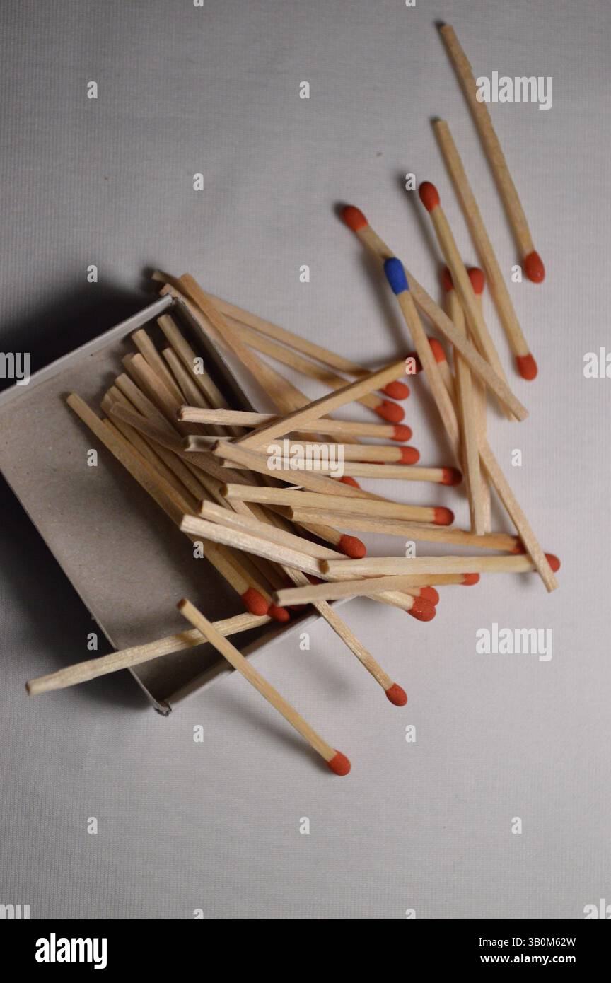 Wooden matches spilled from a matchbox, creating a rustic and slightly ...