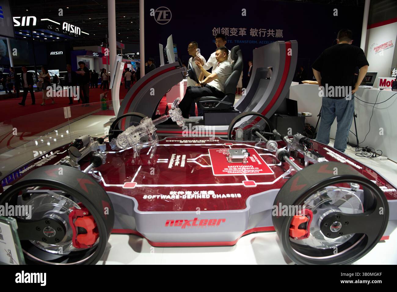 A visitor tries out a driving platform at the booth for auto parts manufacturer Nexteer ...