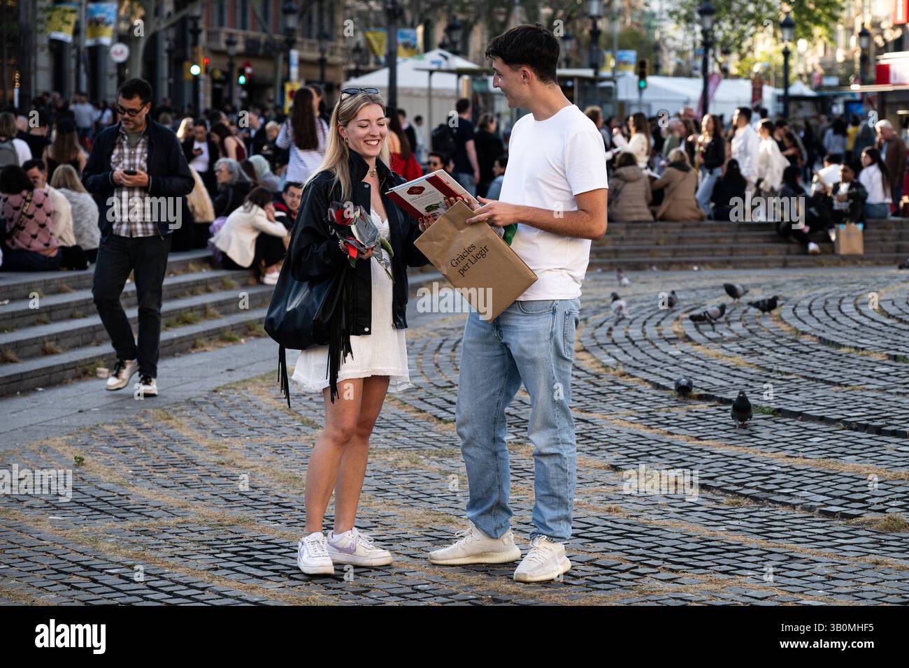 Sant Jordi festival in Barcelona A couple exchanges roses and books as ...