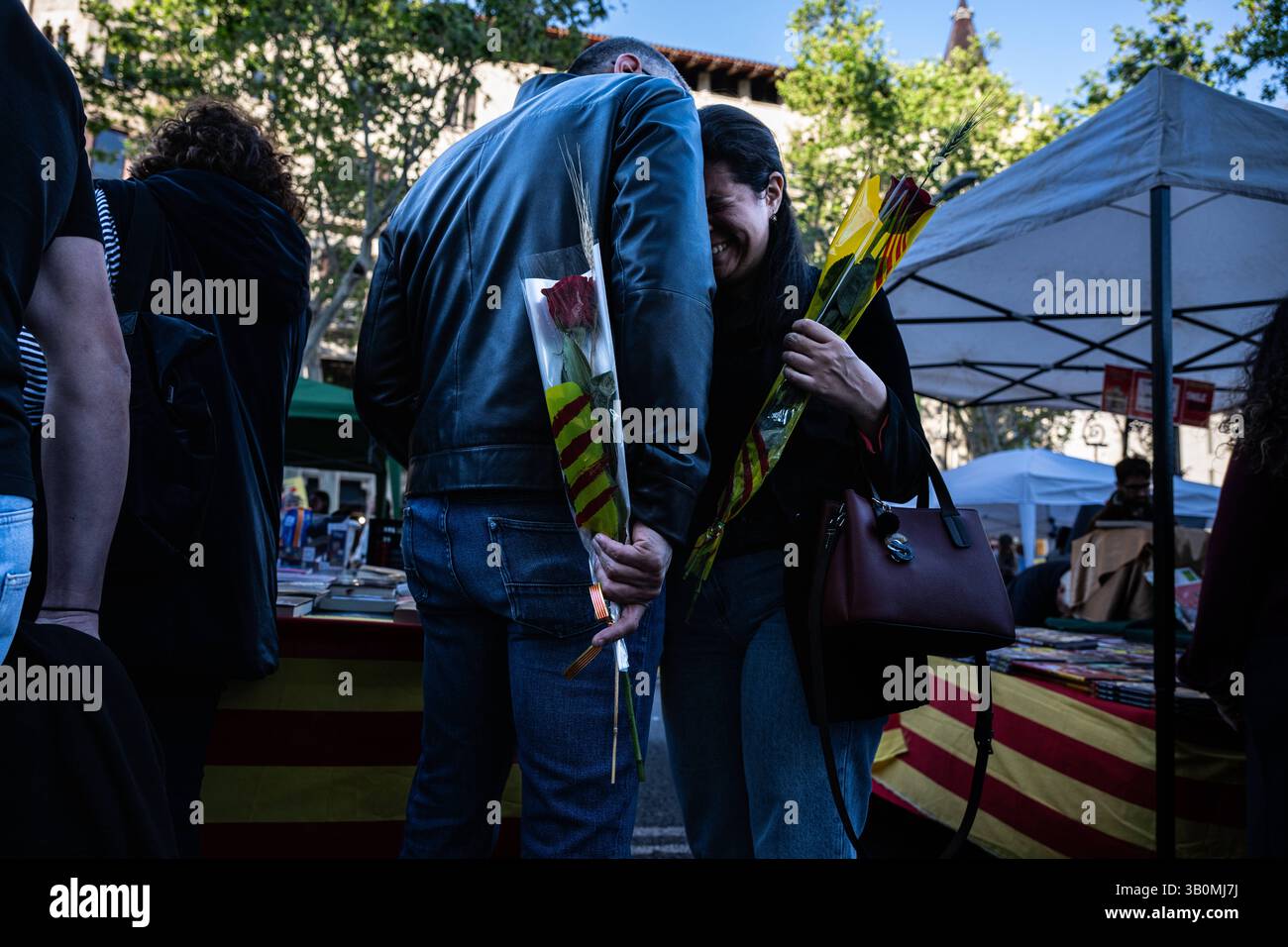 Sant Jordi festival in Barcelona A couple exchanges roses as part of ...