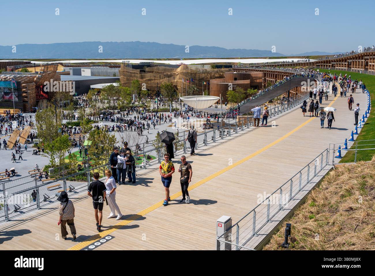Osaka, Japan - April 21 2025 : Visitors walking and resting along the ...