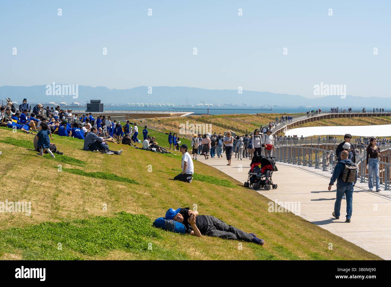 Osaka, Japan - April 21 2025 : Visitors walking and resting along the ...