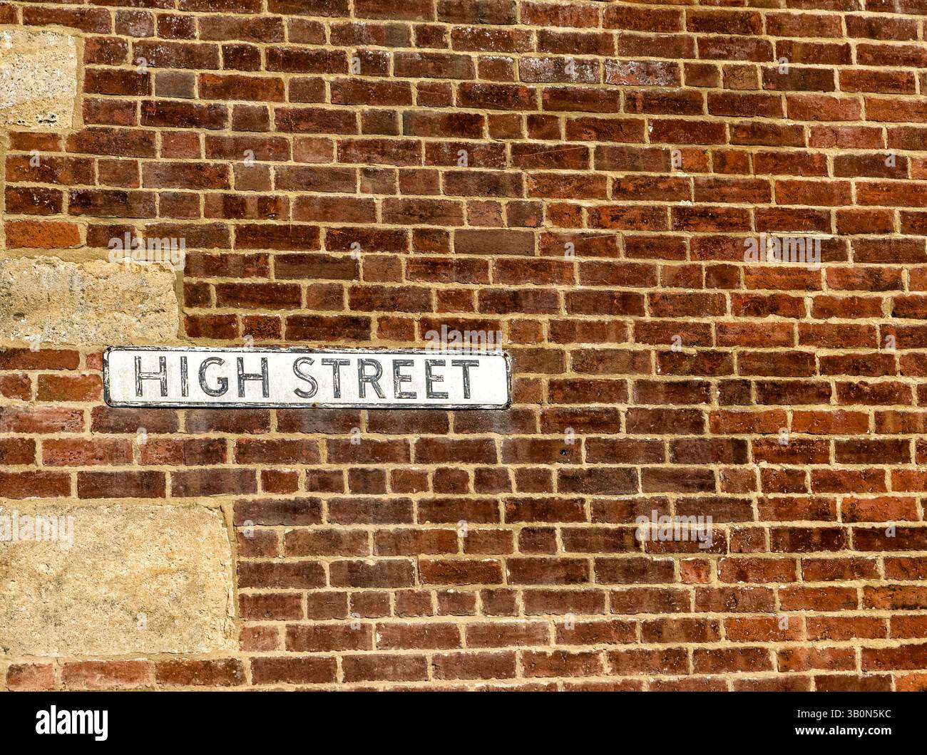 High Street road sign on old brick wall in Cotswold village, United ...