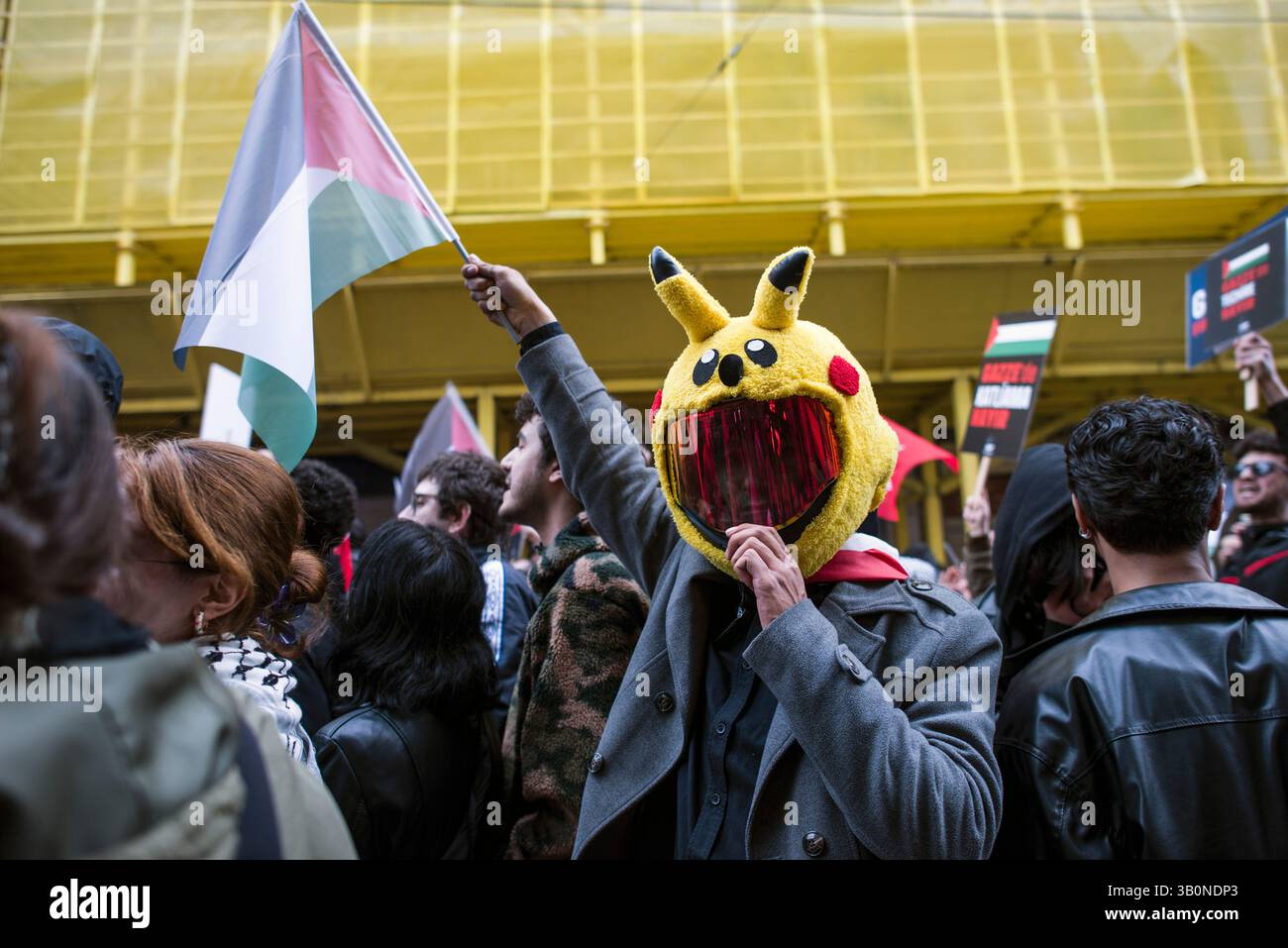 Istanbul, Turkey. 19th Apr, 2025. A man in a Pikachu helmet waves the ...