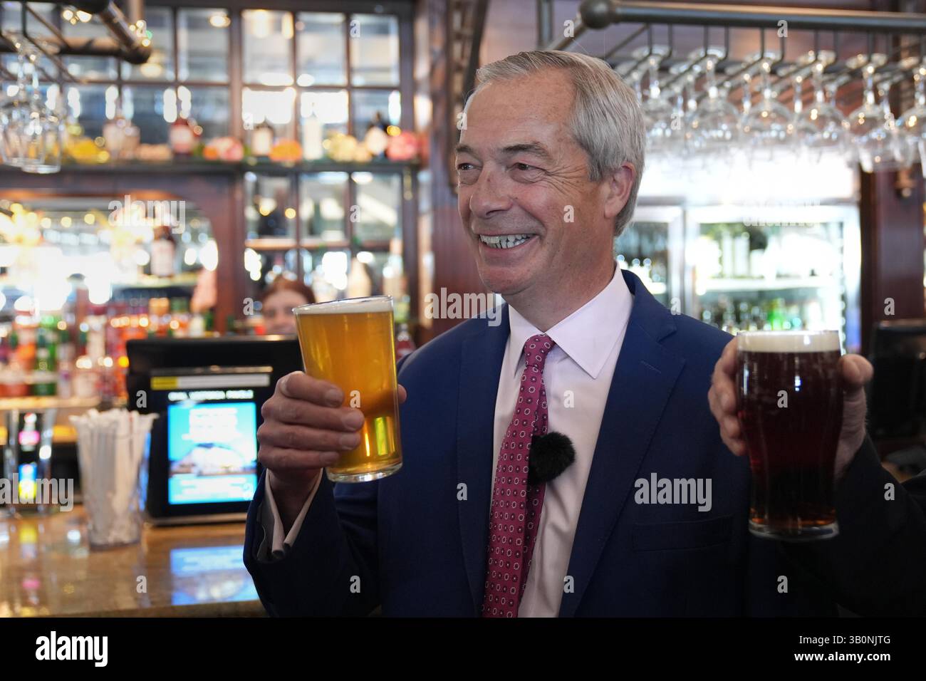 Reform UK leader Nigel Farage has a drink during a visit to the ...