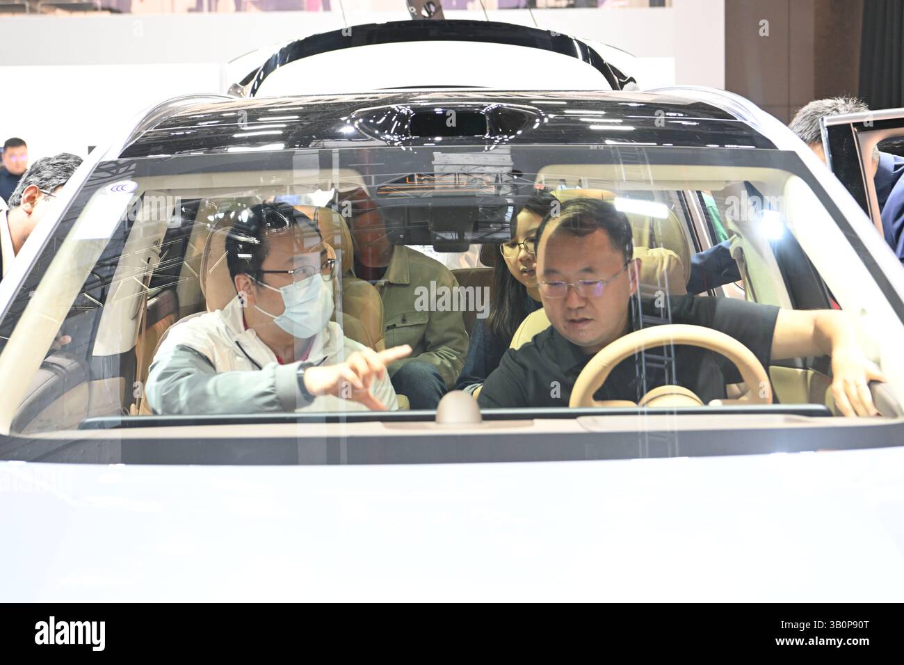 Tourists visited a AITO M8 SUV vehicle on display at the SERES booth at the 2025 Shanghai Auto ...