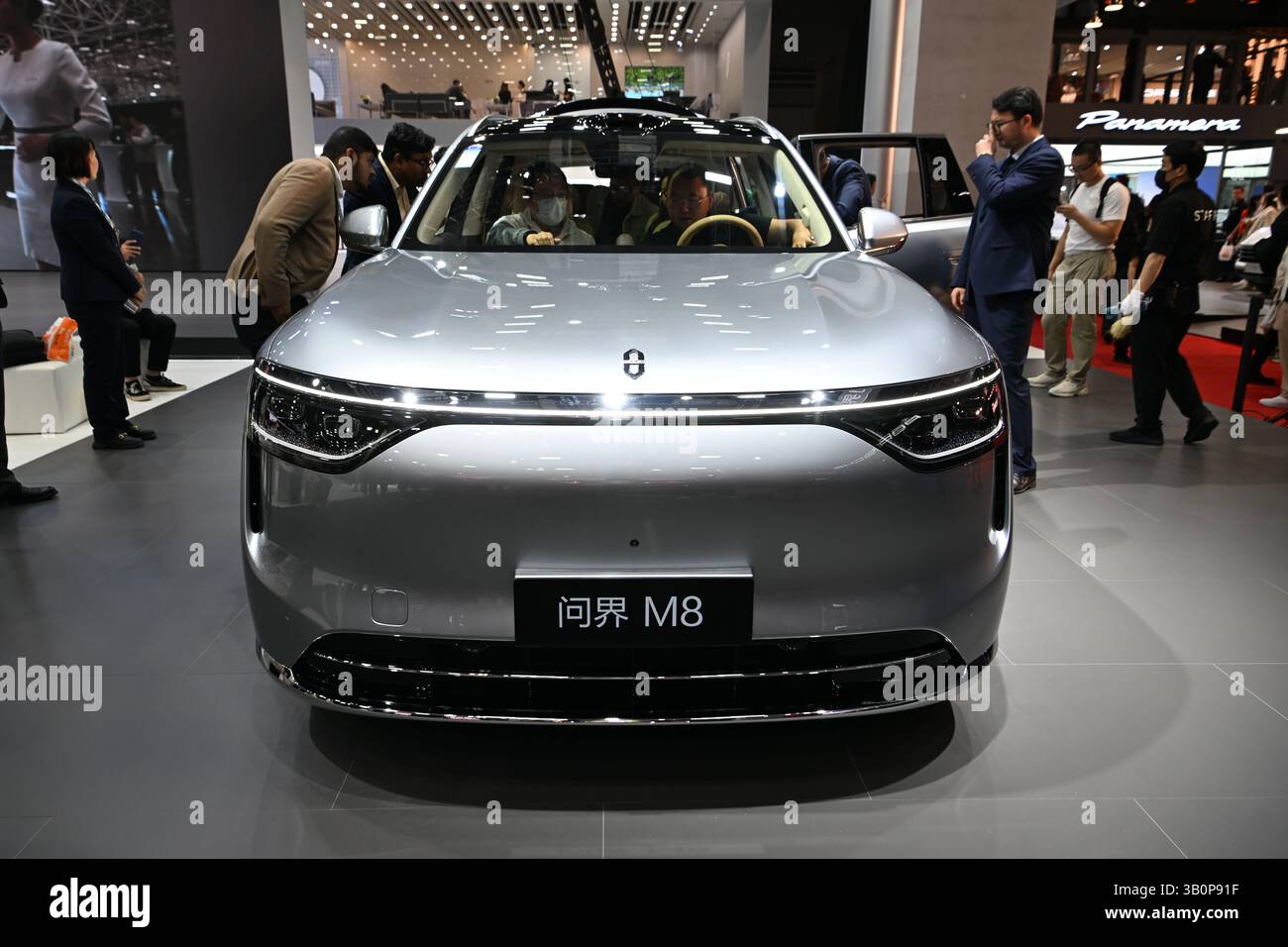 Tourists visited a AITO M8 SUV vehicle on display at the SERES booth at ...