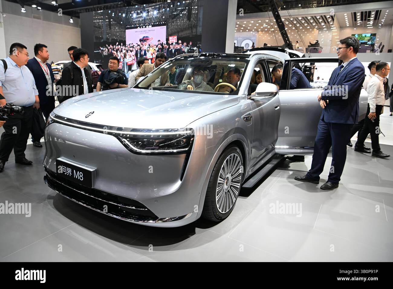 Tourists visited a AITO M8 SUV vehicle on display at the SERES booth at the 2025 Shanghai Auto ...