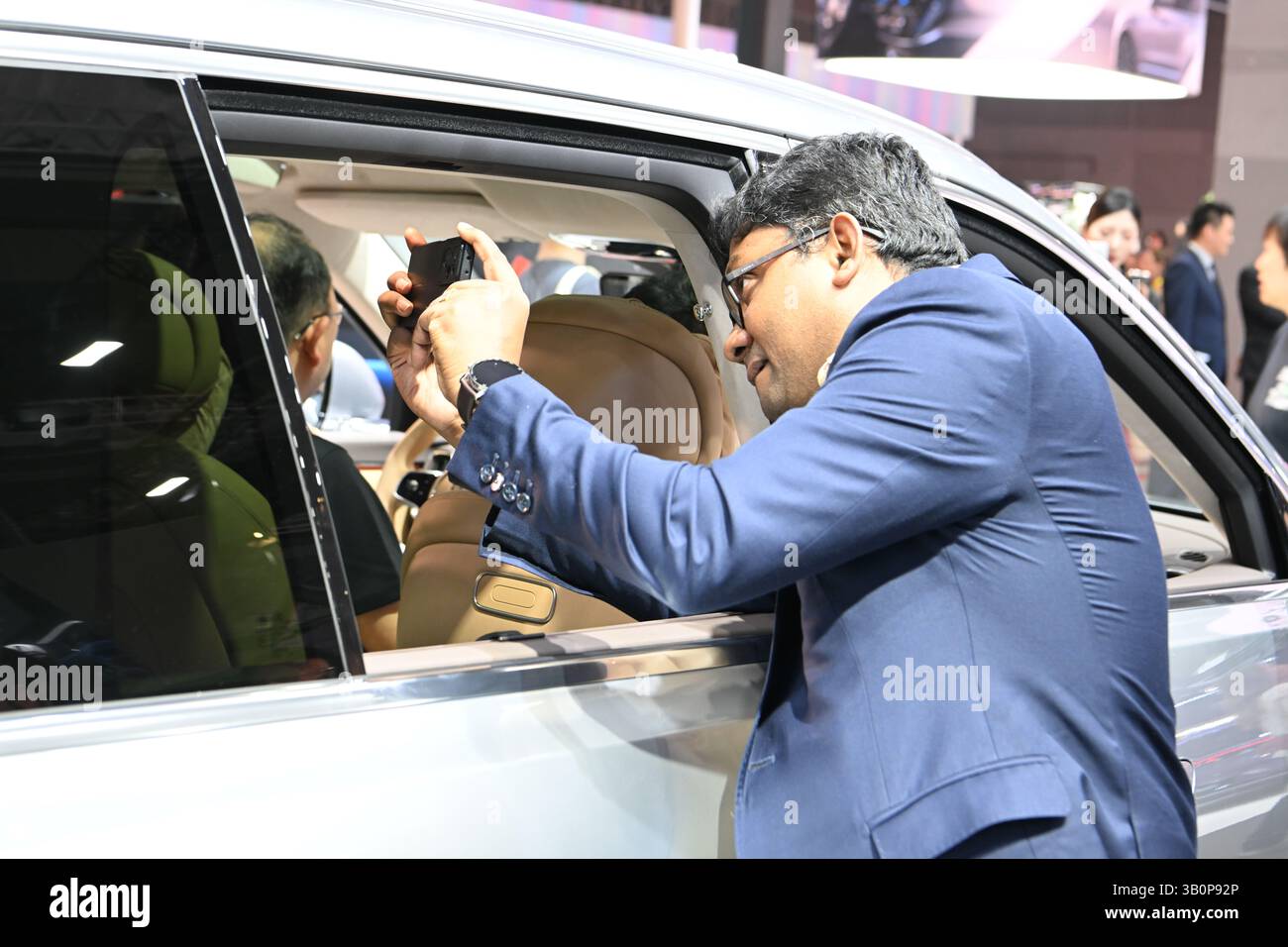 Tourists visited a AITO M8 SUV vehicle on display at the SERES booth at the 2025 Shanghai Auto ...