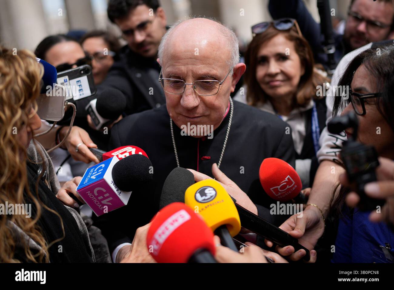 Cardinal Fernando Filoni is approached by reporters as he leaves the ...