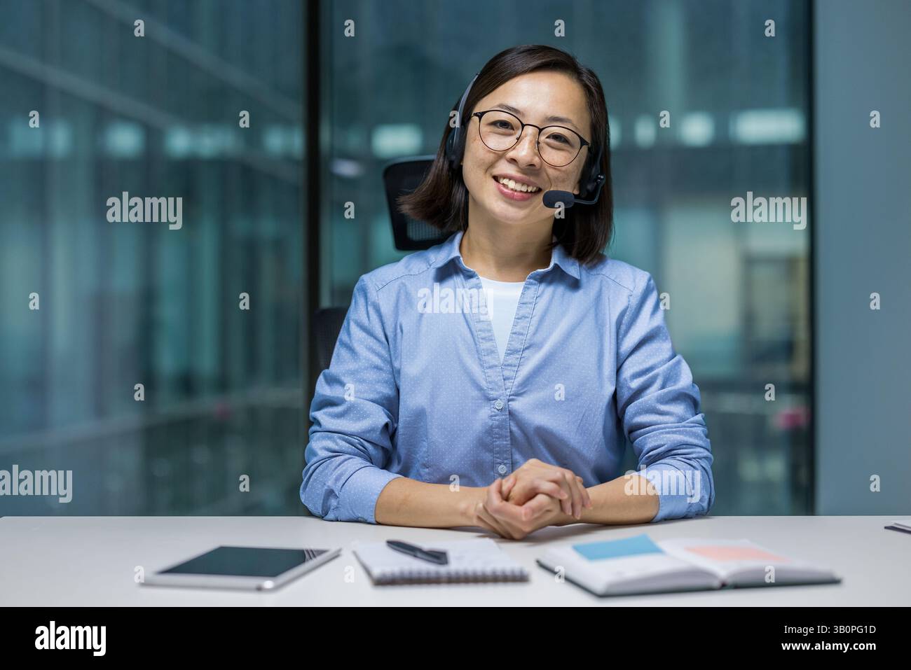 Webcam view, female support worker with headset smiling and looking at ...
