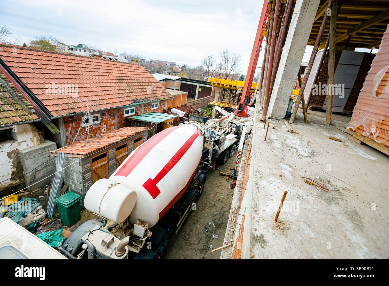Mixer truck is in process of transshipment at building site. Pouring ...
