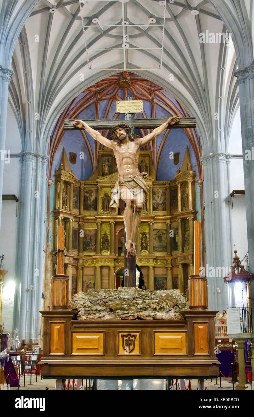 Paso with life-size wooden statue of Jesus Christ crucified on a wooden cross with the main ...