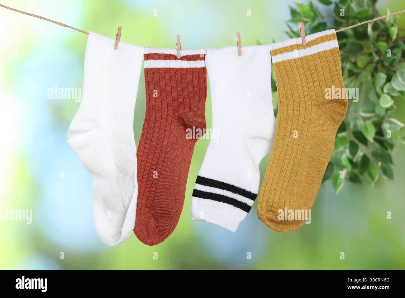 Different socks hanging on washing line outdoors Stock Photo - Alamy