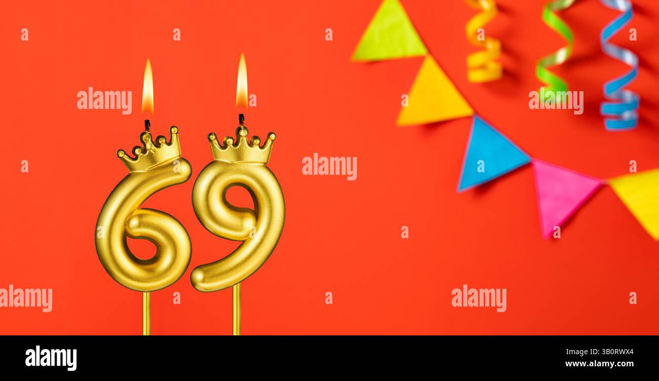 Number 69 birthday candle on an orange background with pennants Stock ...
