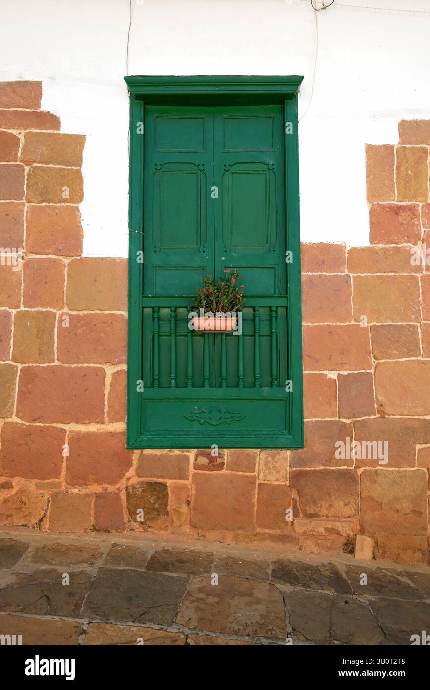 Colombian colonial house in stone with green windows Stock Photo - Alamy