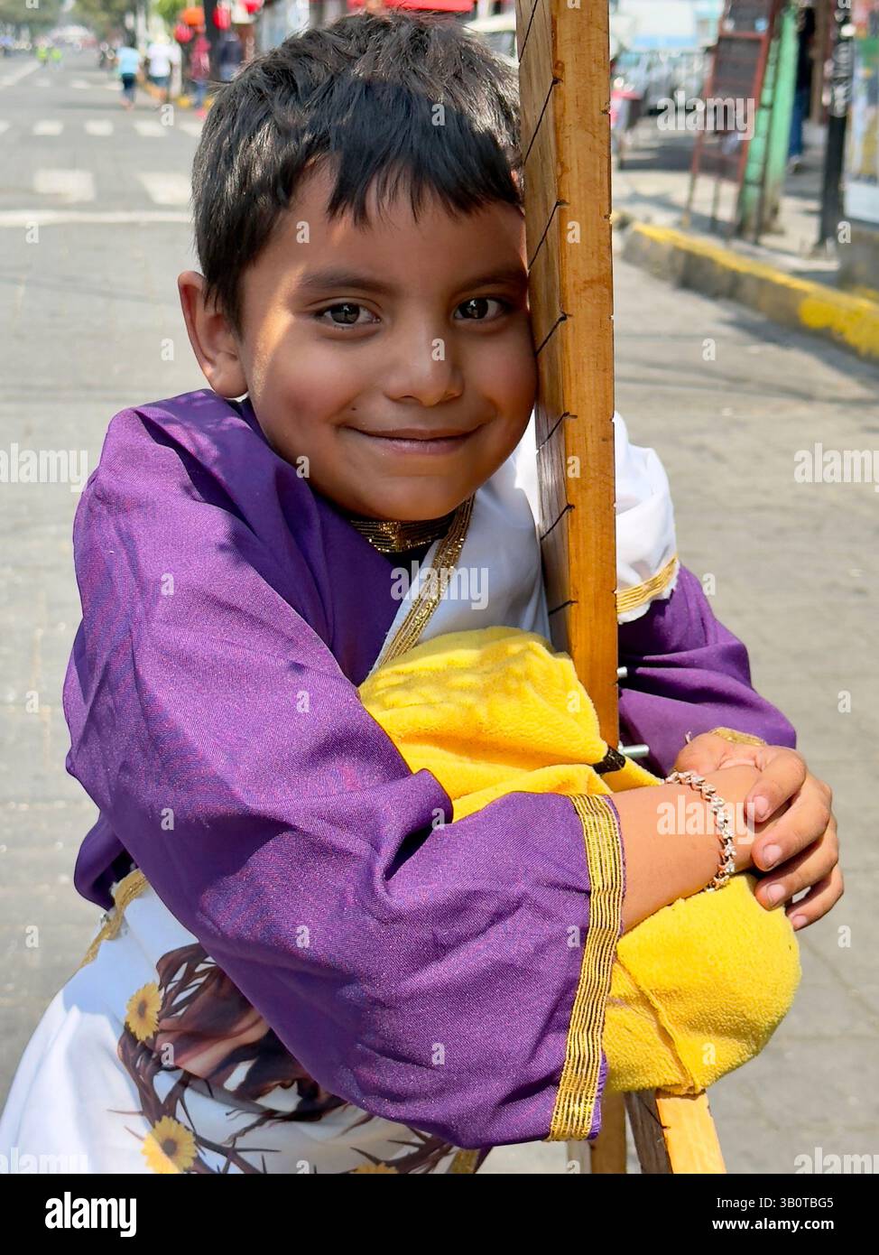 On Holy Friday in Iztapalapa, faithful child carry large wooden cross ...