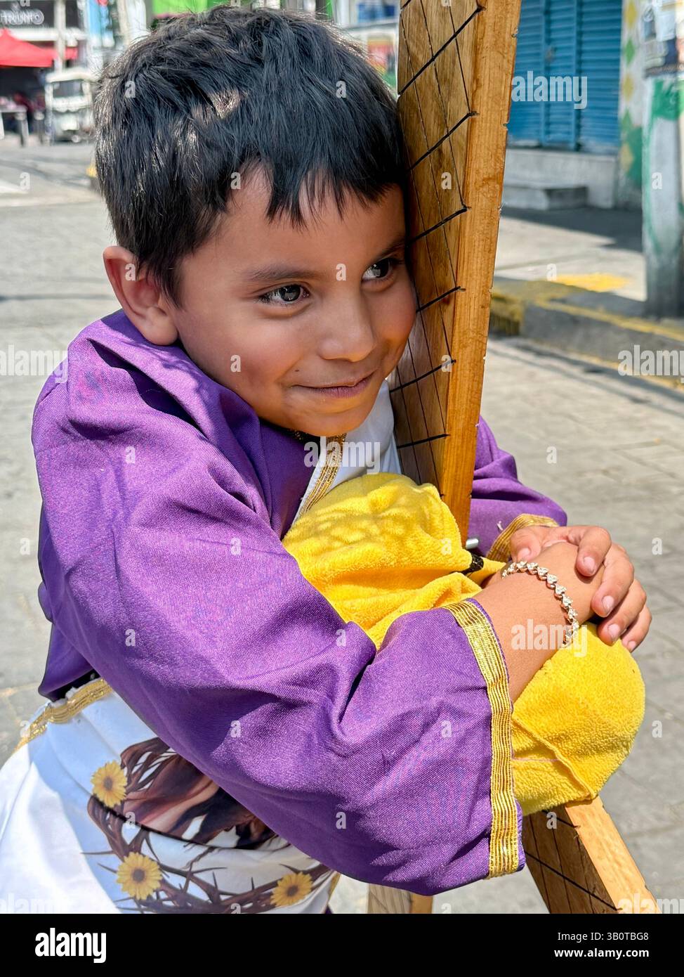 On Holy Friday in Iztapalapa, faithful child carry large wooden cross ...
